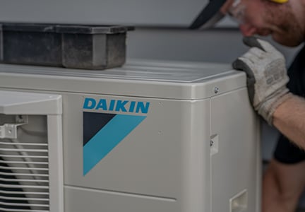 HVAC tech working on unit